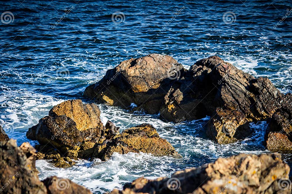 Rocks by ocean water stock photo. Image of ocean, waves - 318405040
