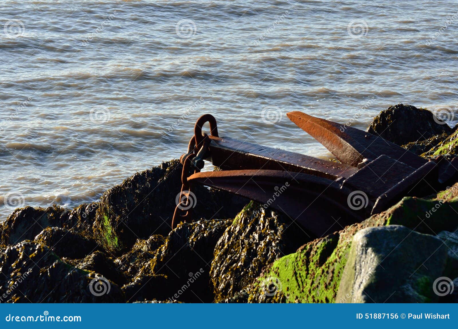 Large Rusty Anchor on Group of Rocks Stock Photo - Image of coastline ...