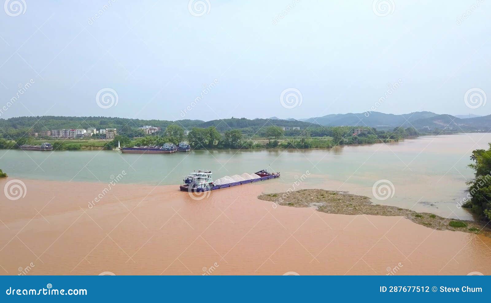 A Large Sand Mining Ship Sailed Past the Confluence of Two Rivers, the ...
