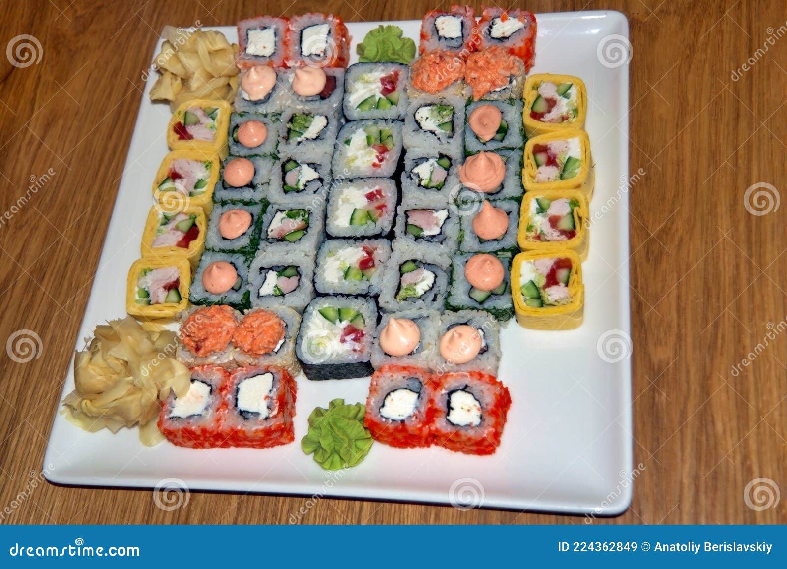 A Large Set of Different Rolls on a Large Dish on a Wooden Table in a ...