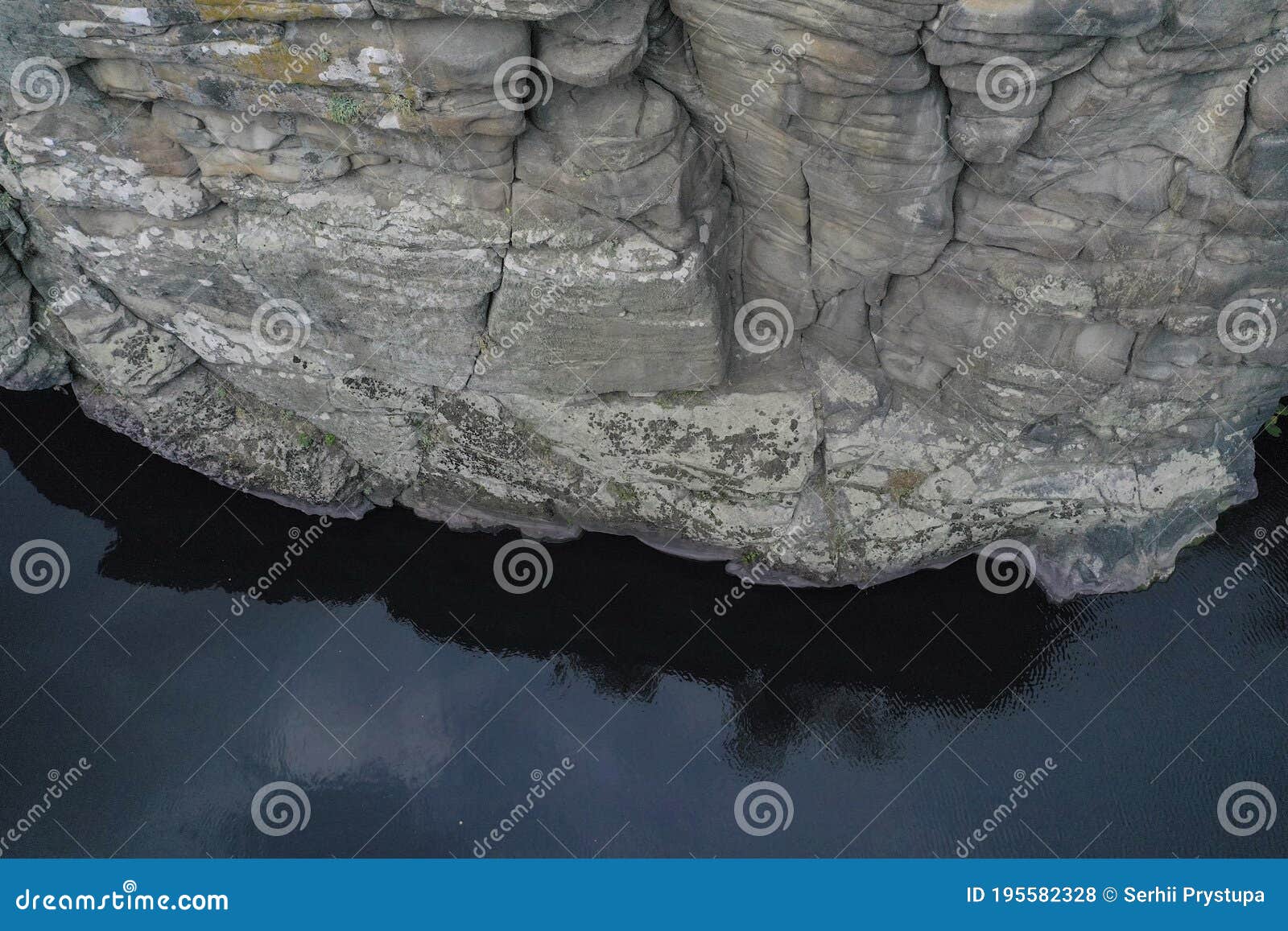 A Large Sheer Cliff Above the Water Stock Photo - Image of pattern ...