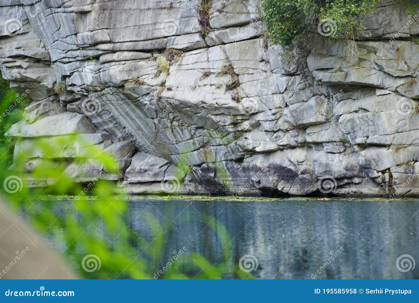 A Large Sheer Cliff Above the Water Stock Photo - Image of countryside ...