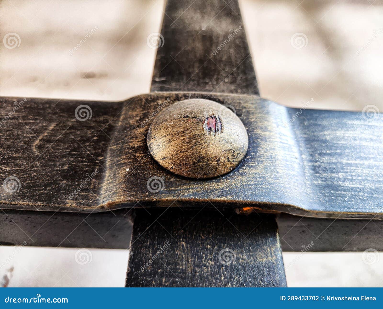 A Large Shiny Copper Round Metal Rivet at the Intersection and Cross of ...
