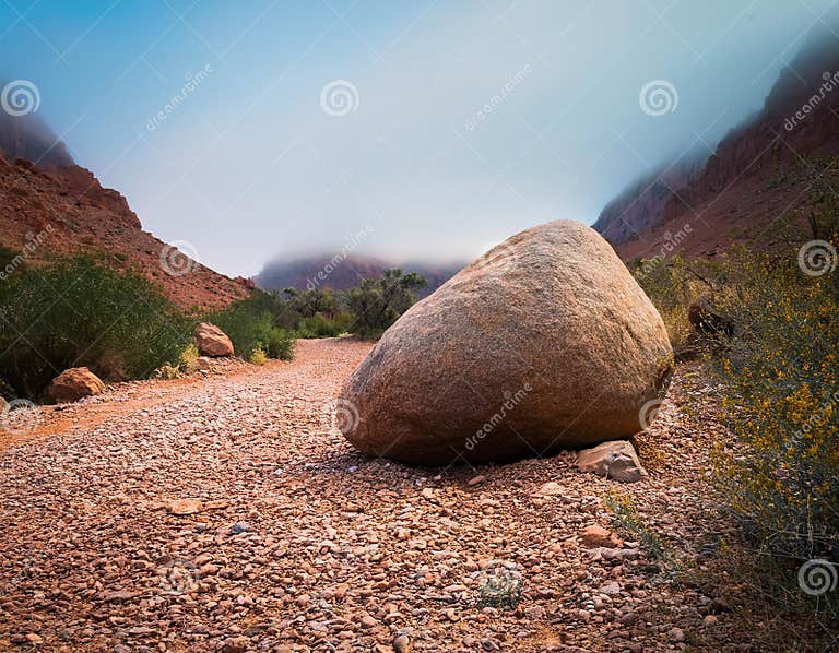 A Large, Smooth Boulder Surrounded by Tiny Pebbles and Rugged Gravel ...