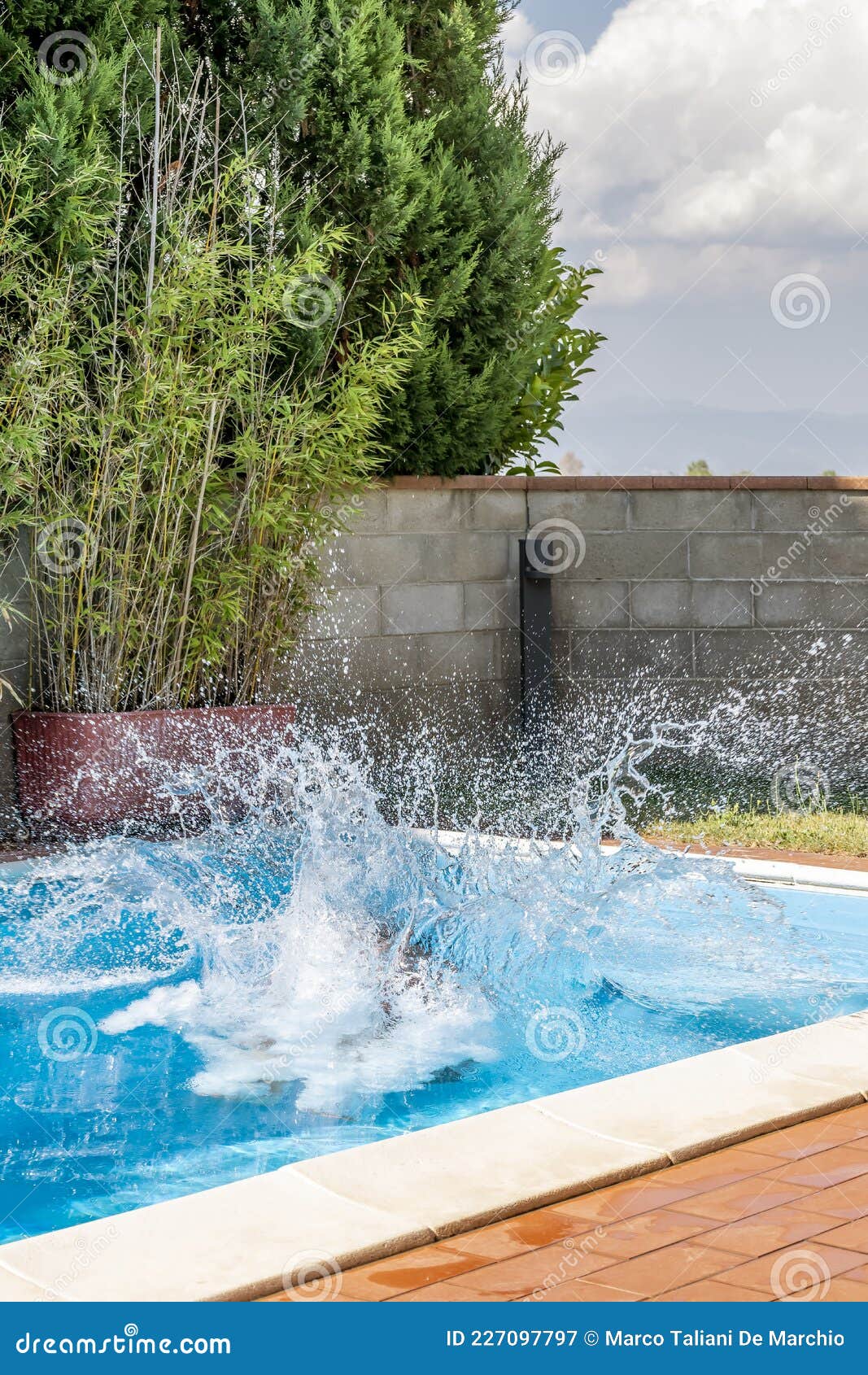 A Huge Splash of Water is Created by a Cannonball Dive into a Swimming ...