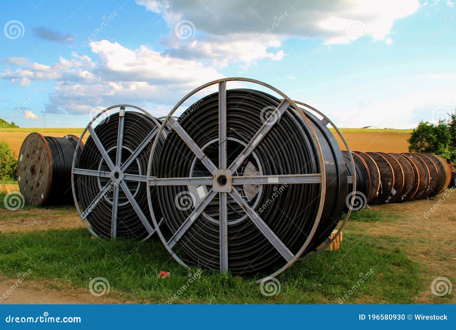 Spools of Electric Cable in a Field Stock Photo - Image of industry ...