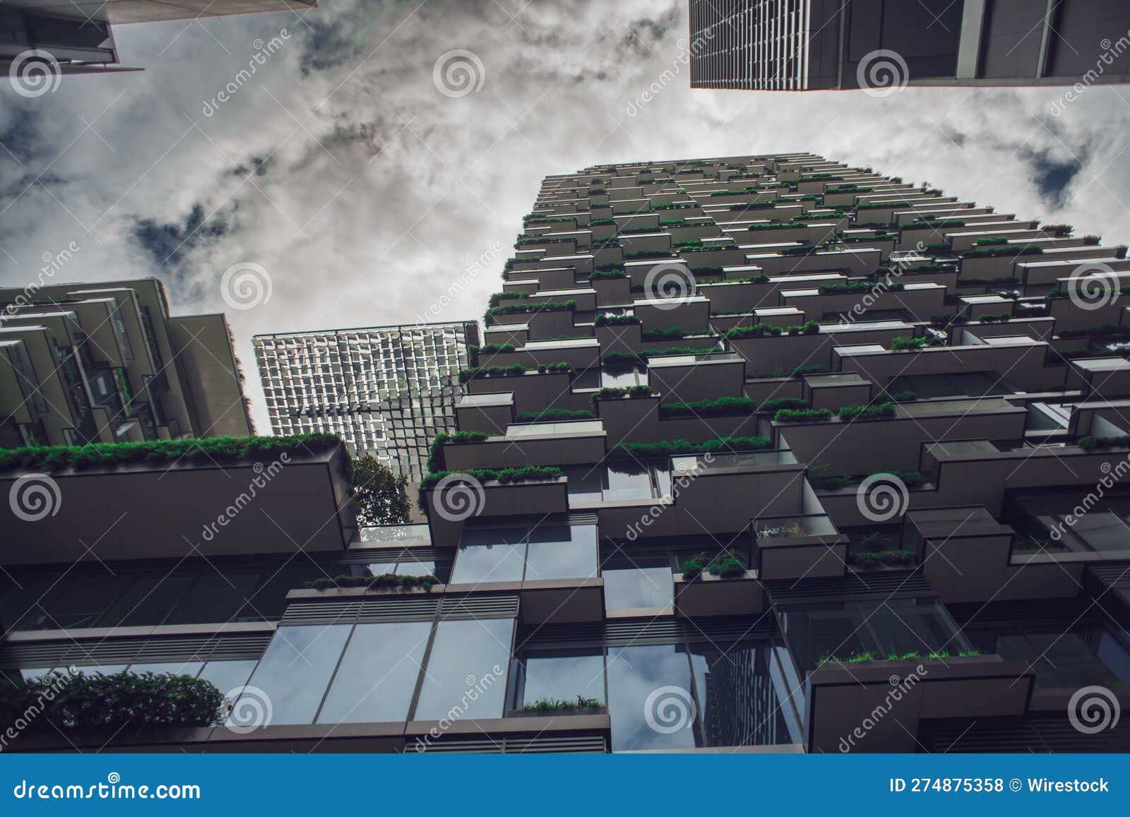 Large, Sprawling Building with Several Windows and Lush Plants Growing ...