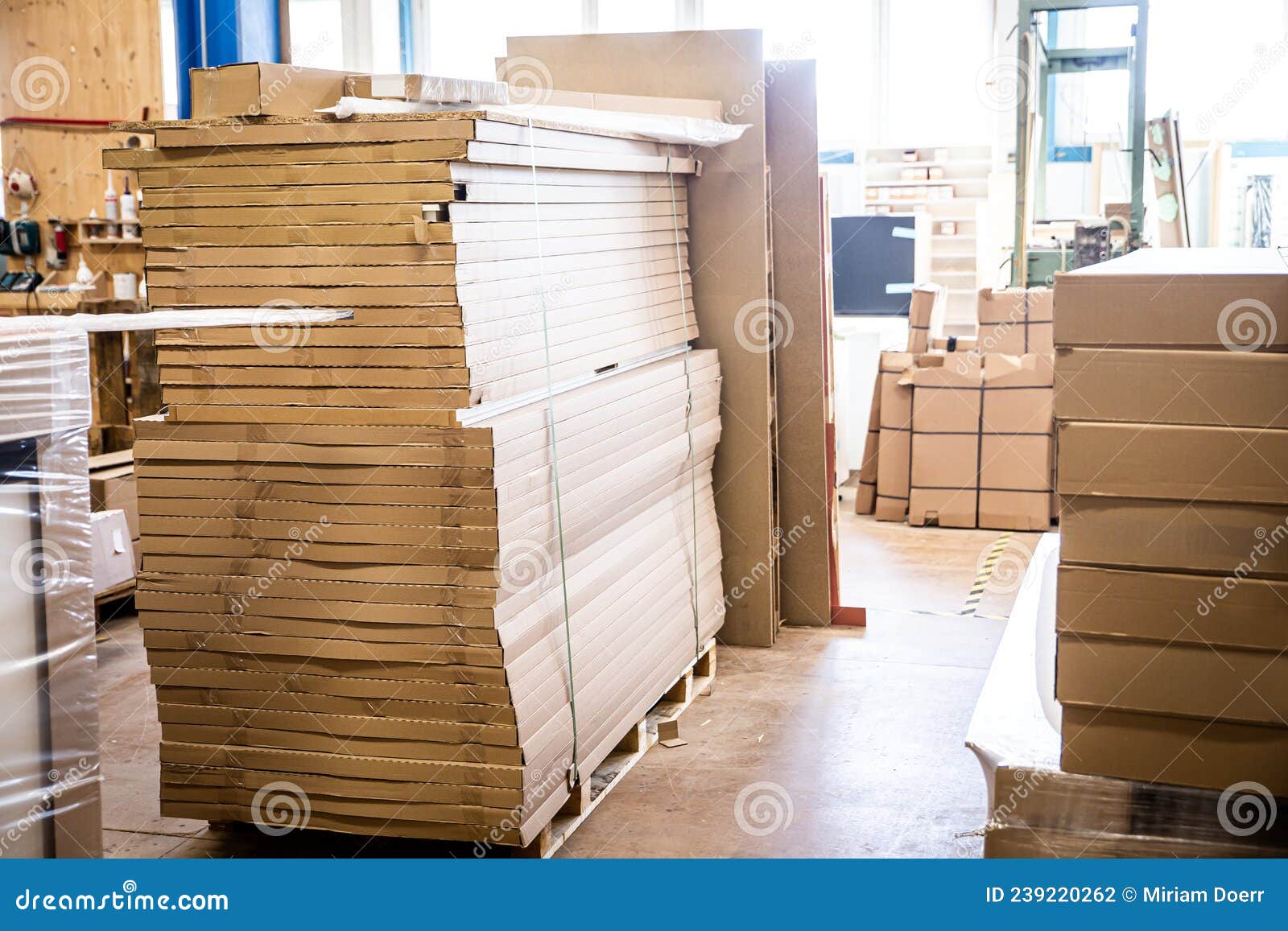 A Large Stack of Goods Packed in Cartons in a Warehouse or Workshop ...