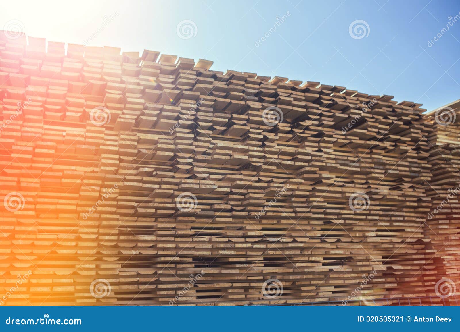 A Large Stack of Lumber Boards is Neatly Stacked at a Lumber Yard. the ...