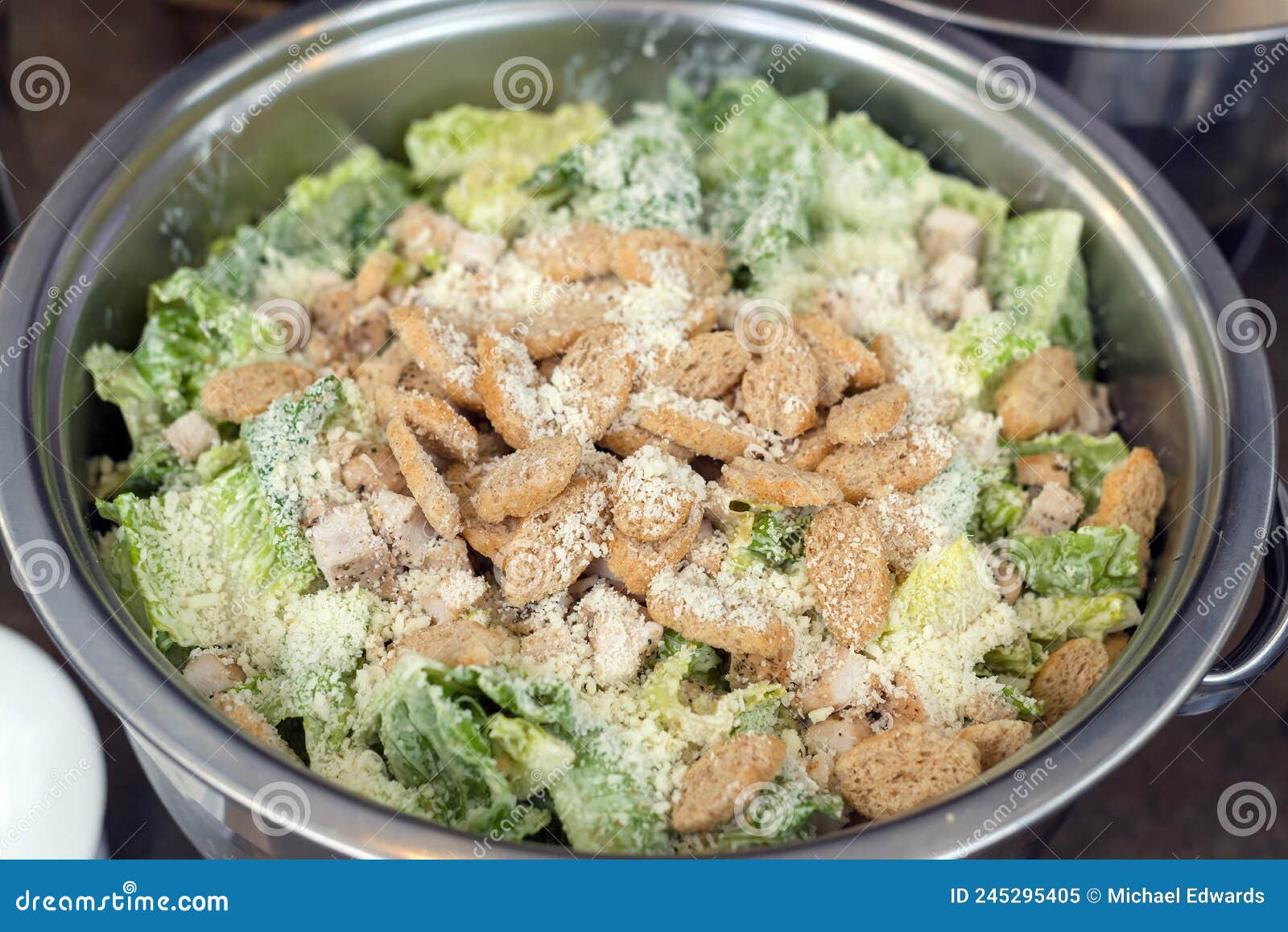 A Large Stainless Bowl of Caesar Salad on a Catering Table Served for ...