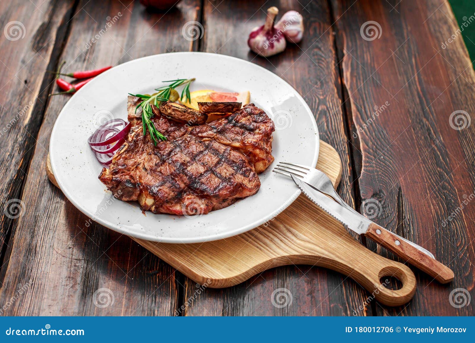 A Large Steak with Spices and Vegetables on the Grill Stock Photo ...