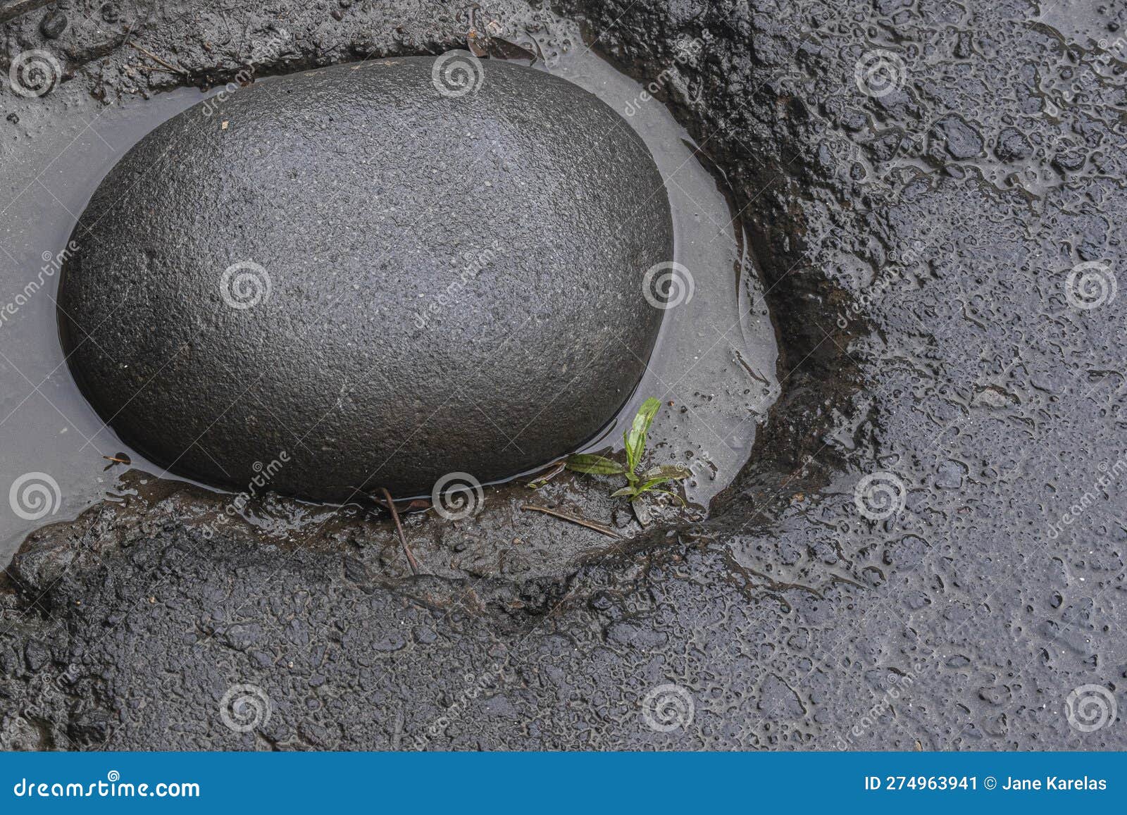 Large Stone in Puddle on Pavement Stock Image - Image of abstract, rain ...