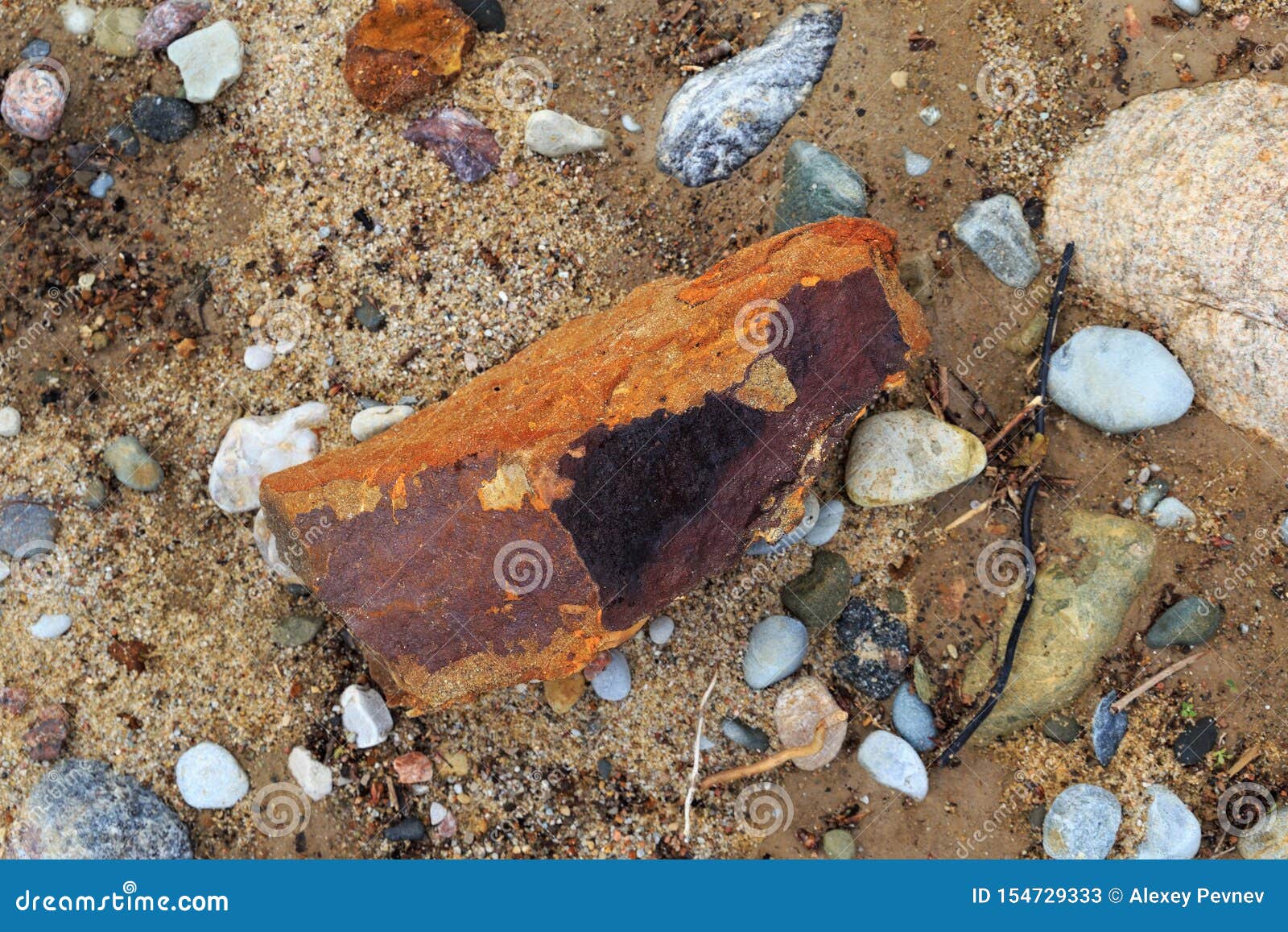 Large Stone of Rust Colored, Surrounded by Smaller Stones Stock Image ...