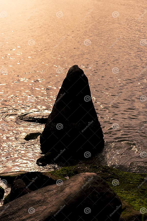 Triangular Stone in the Sea Stock Image - Image of wave, background ...