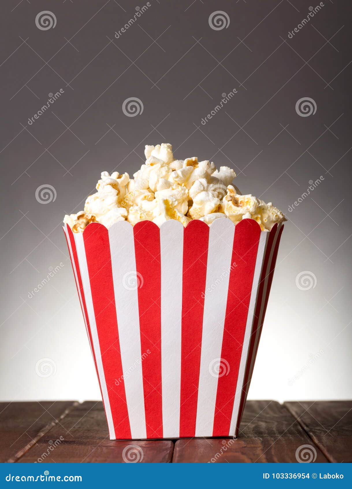 Large Striped Square Box Filled with Popcorn on Gray Background. Stock ...