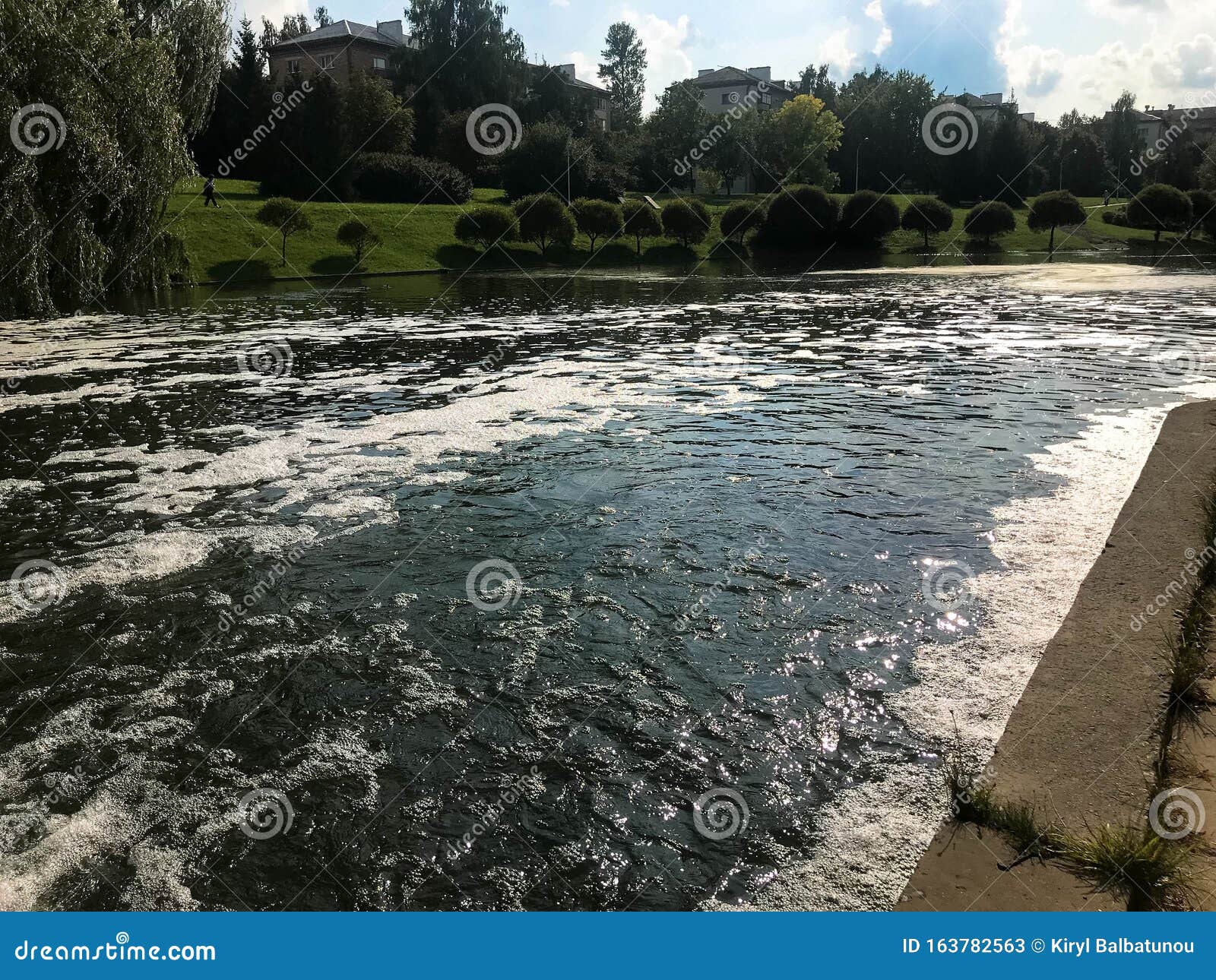 A Large Strong Flow of Water in an Artificial Pond River Stock Image ...