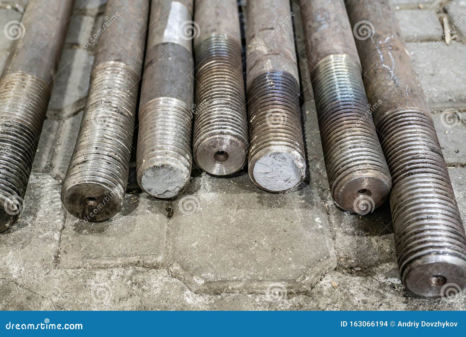 A Large Threaded Rod Lies on the Floor in the Workshop Stock Photo ...