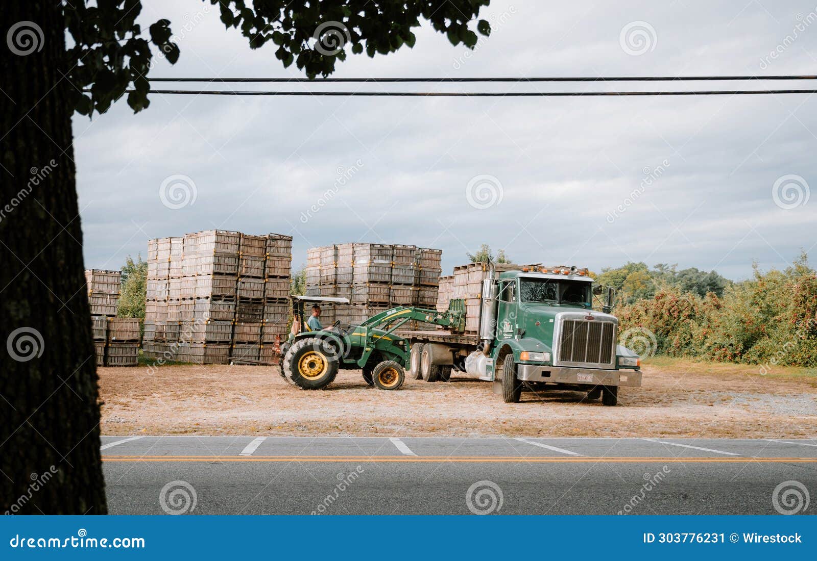 Large Tractor Hauling Several Large Boxes in an Open Field in ...