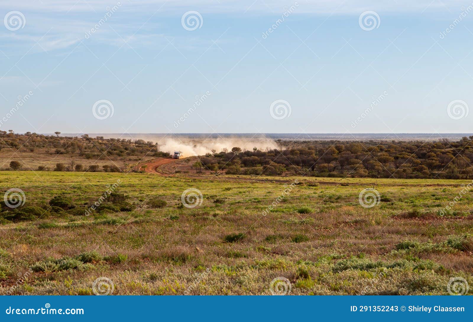 A Large Truck Kicking Up a Dust Cloud in the Distance Stock Image ...