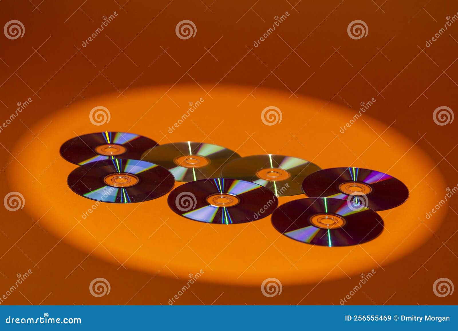 Large Variety of Arranged CD Disks or DVD Disks on Orange Background ...