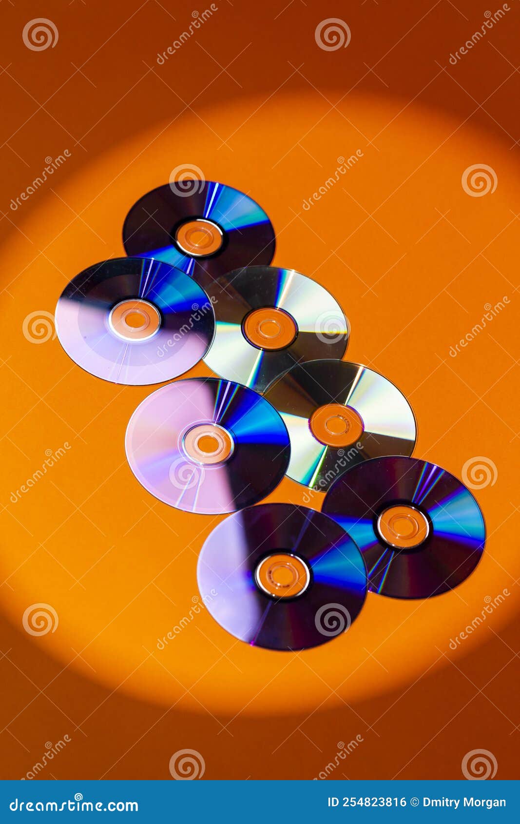 Large Variety of Arranged CD Disks or DVD Disks on Orange Background ...