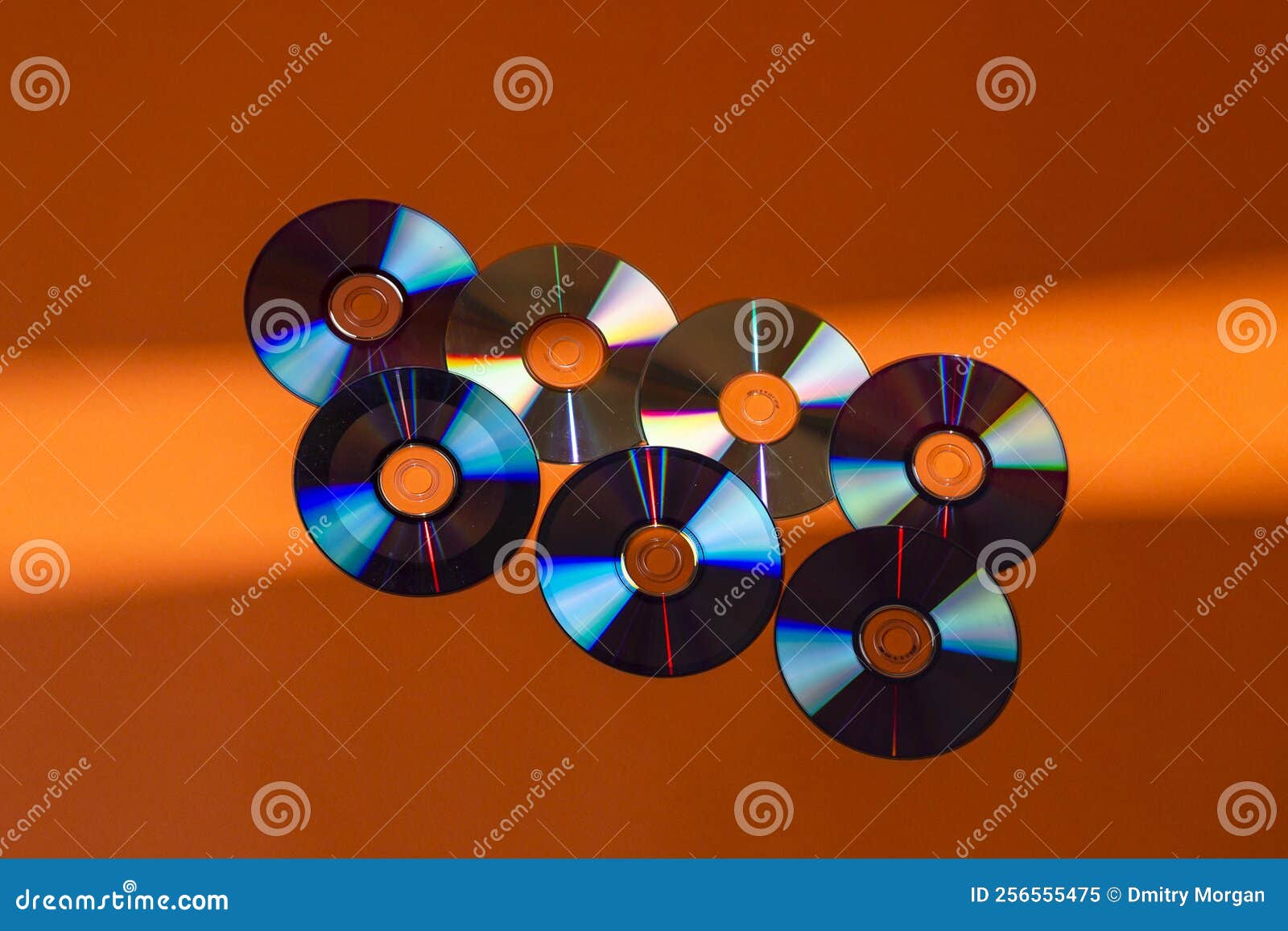 Large Variety of Arranged CD Disks or DVD Disks on Orange Background ...