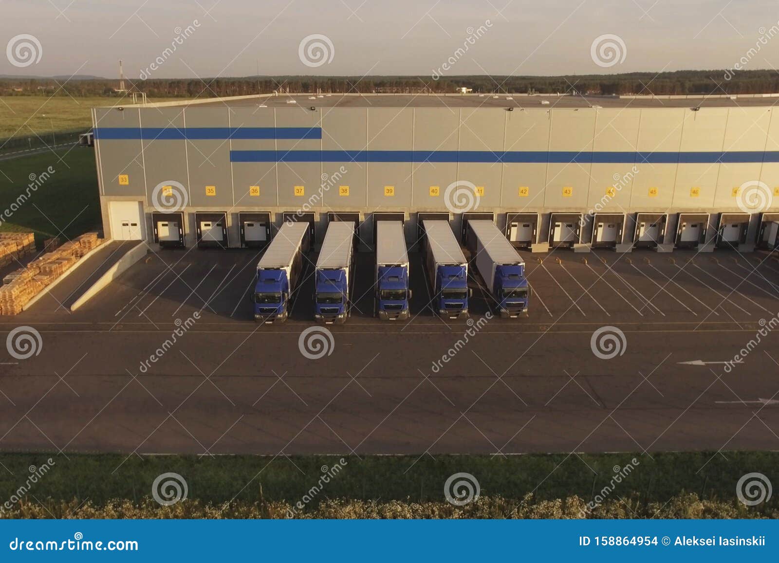 Large Warehouse Complex with Parked Trucks Awaiting Loading. Logistics ...