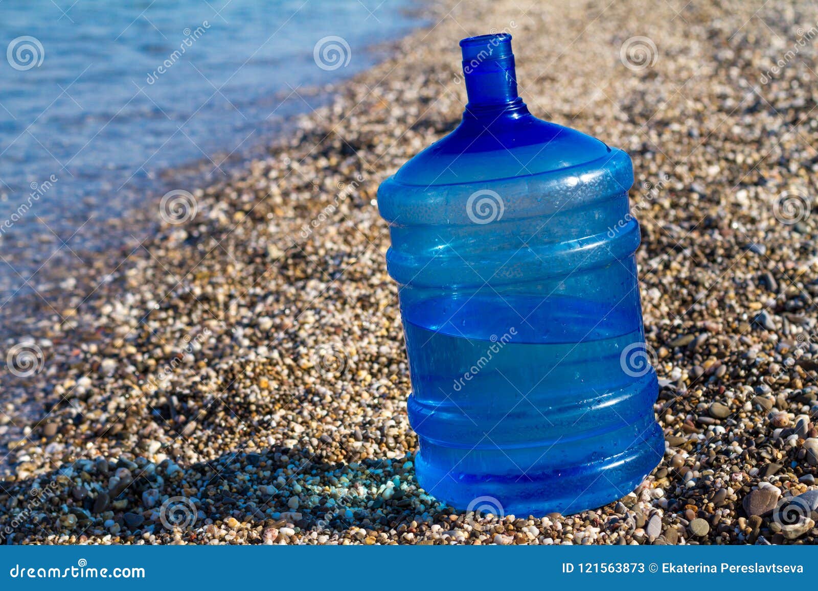 A Large Water Bottle Stands on the Beach, Stock Image - Image of full ...