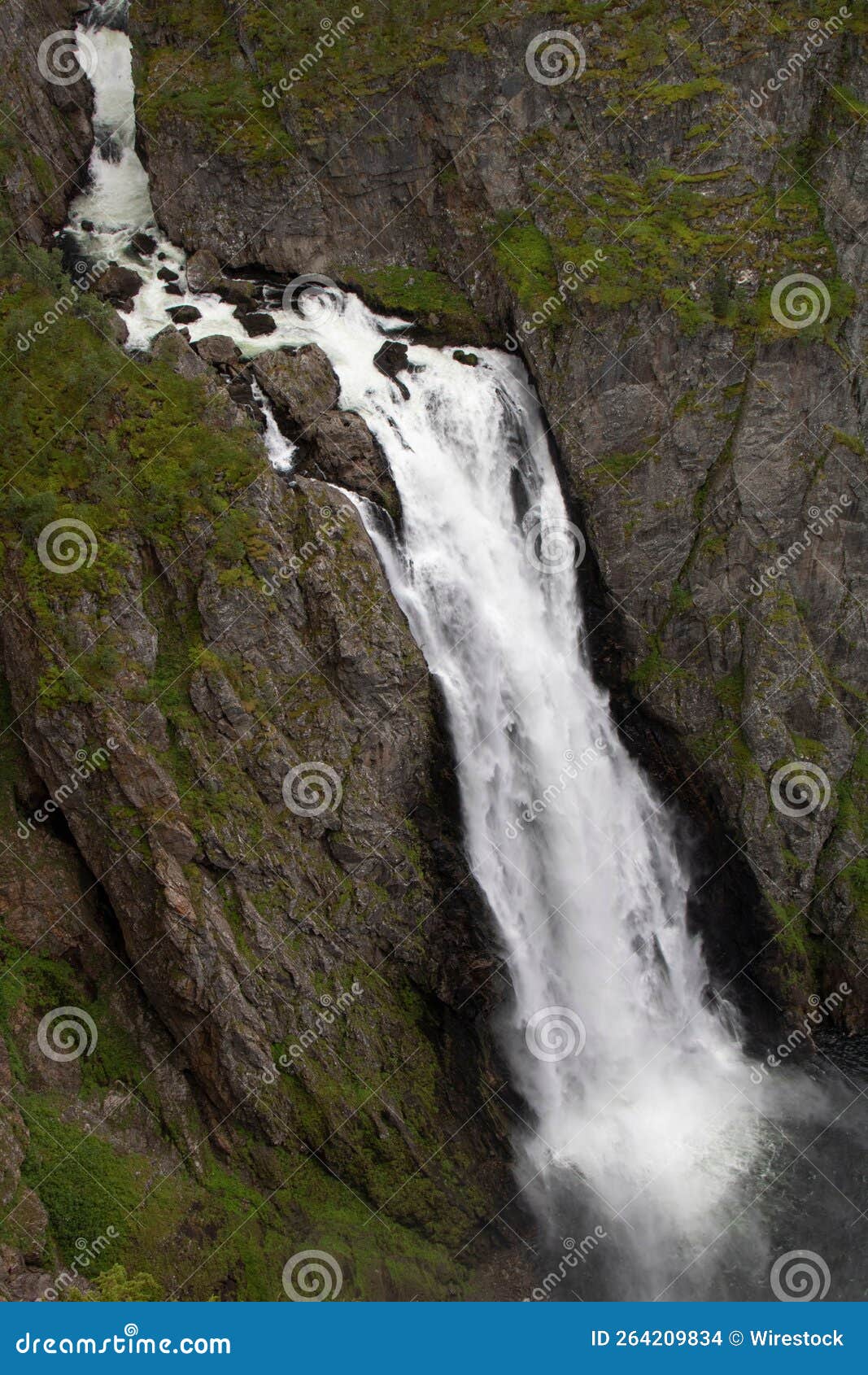 Large Waterfall Flowing Over a Lush Green Hillside Stock Photo - Image ...