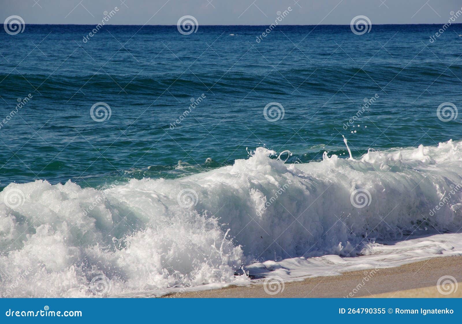 A Large Wave Rolls Ashore on a Windy Sunny Day Stock Image - Image of ...
