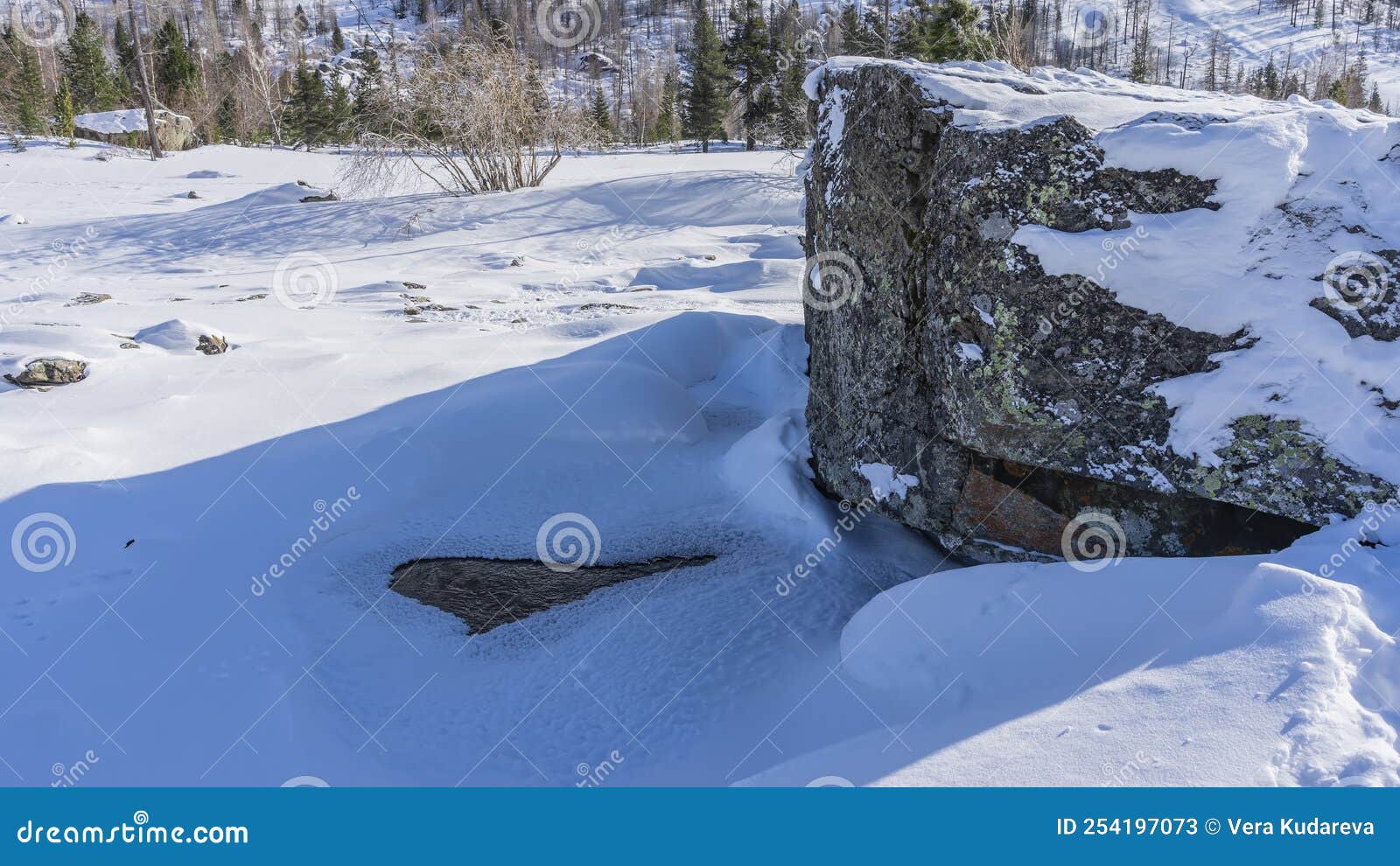 A Large Weathered Boulder is Covered with a Layer of Snow. Stock Image ...