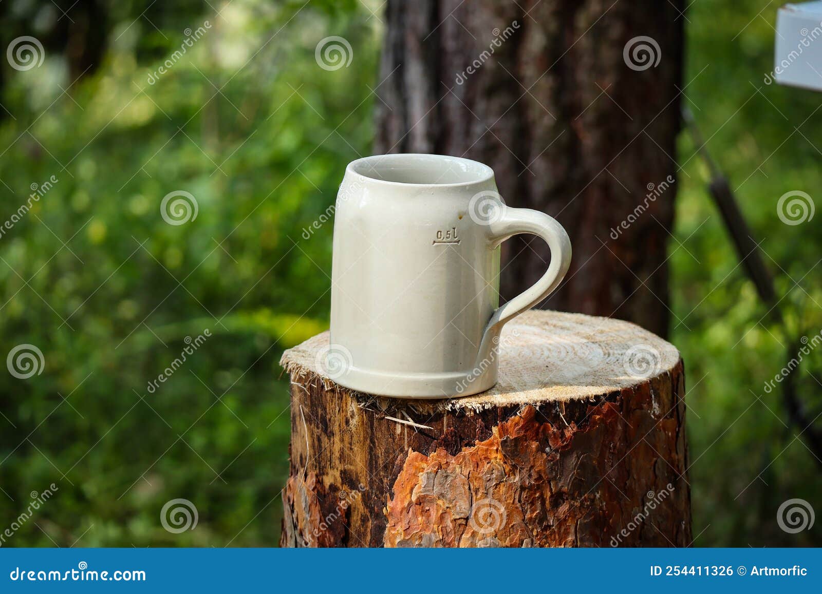 Large White Ceramic Beer Cup with Handle Standing on Cut Tree Stump in ...