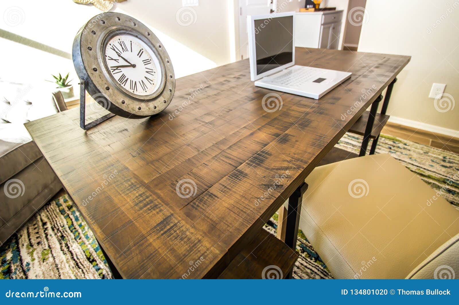 Large Wooden Desk with Clock and Laptop Stock Photo - Image of room ...