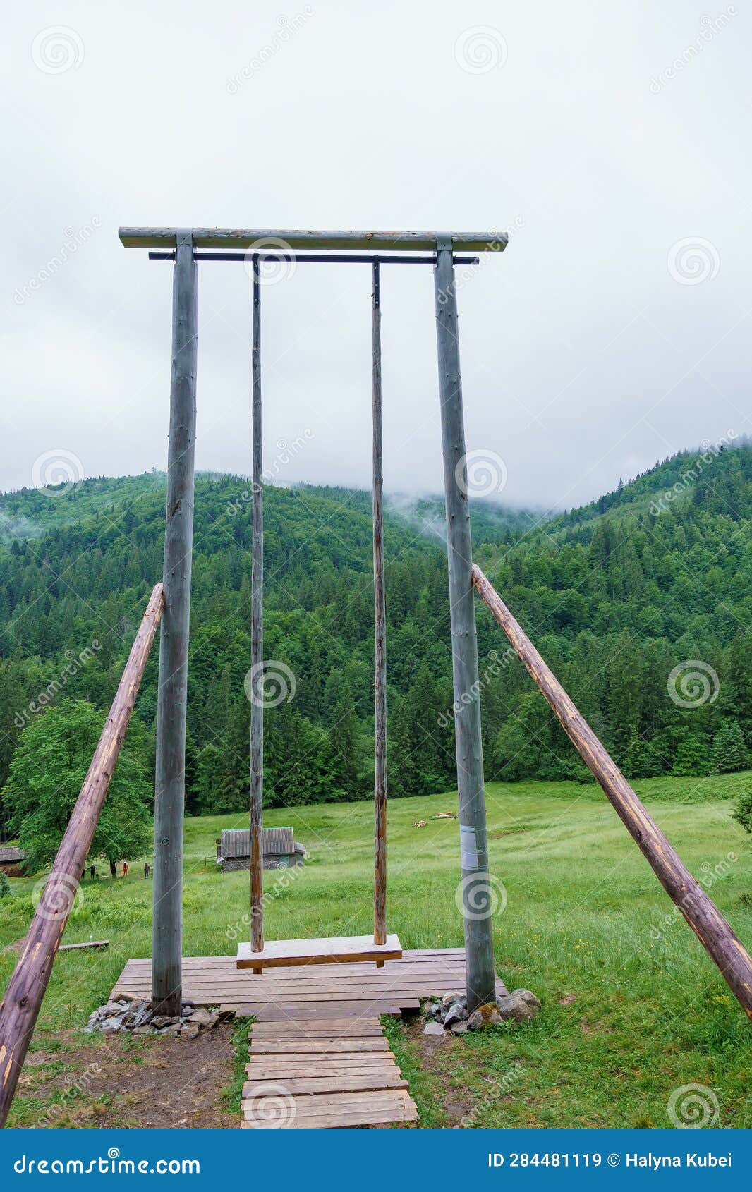 Large Wooden Swing on Top of a Mountain, Forest in the Background Stock ...