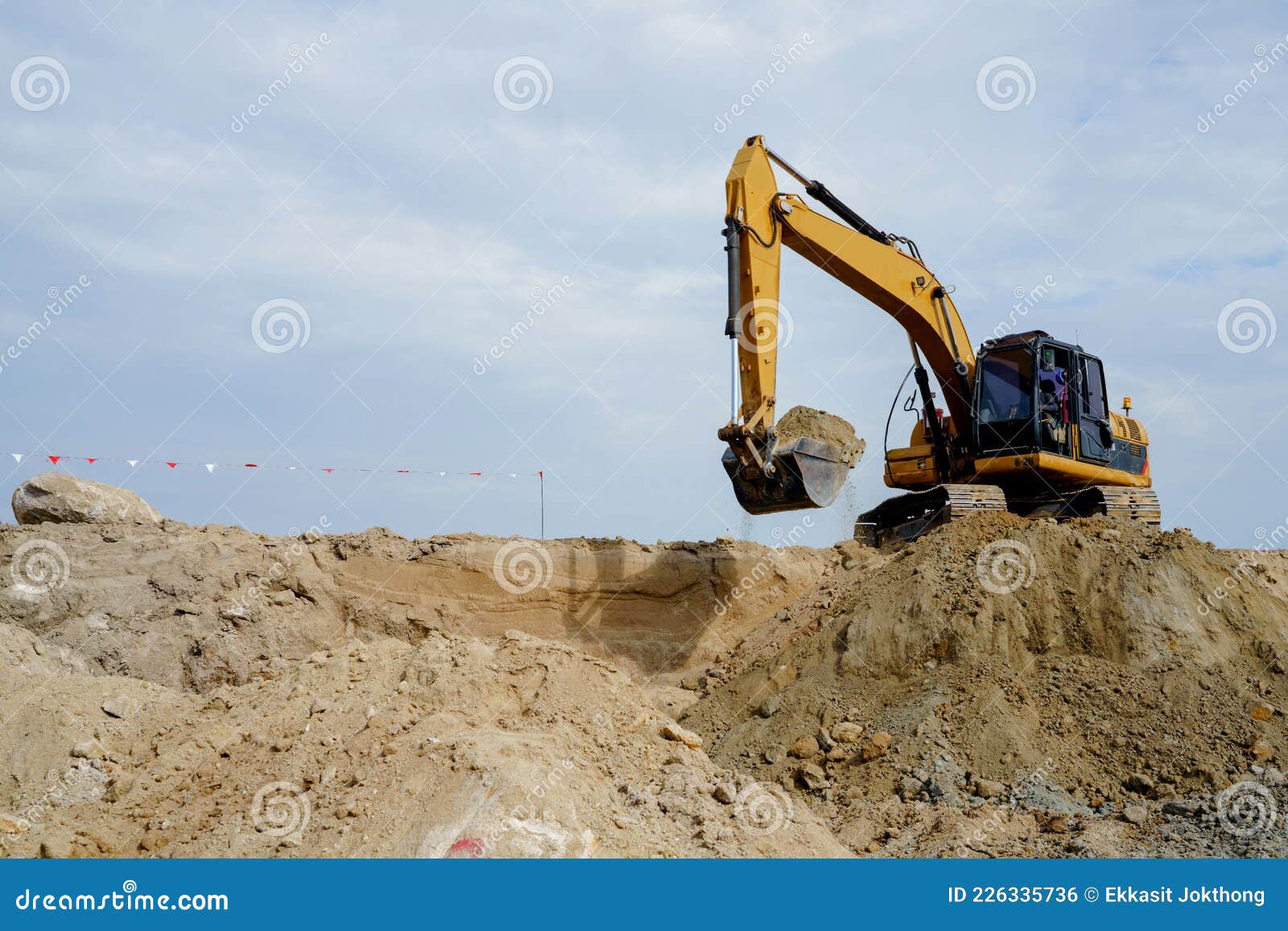 Yellow Backhoe With Hydraulic Piston Arm Against Clear Blue Sky. Heavy ...