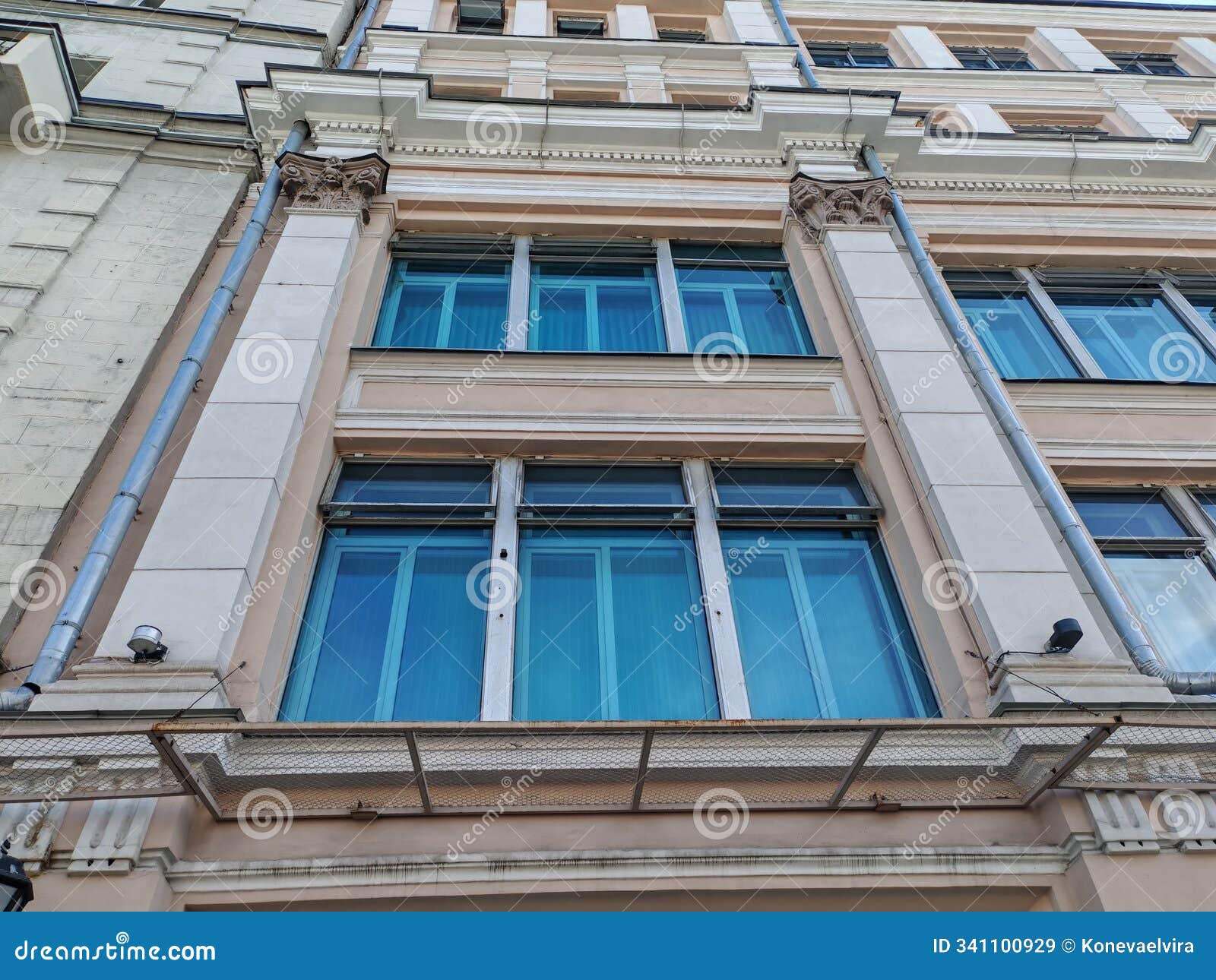 Large Yellow Building with Multiple Windows and an Arched Doorway ...