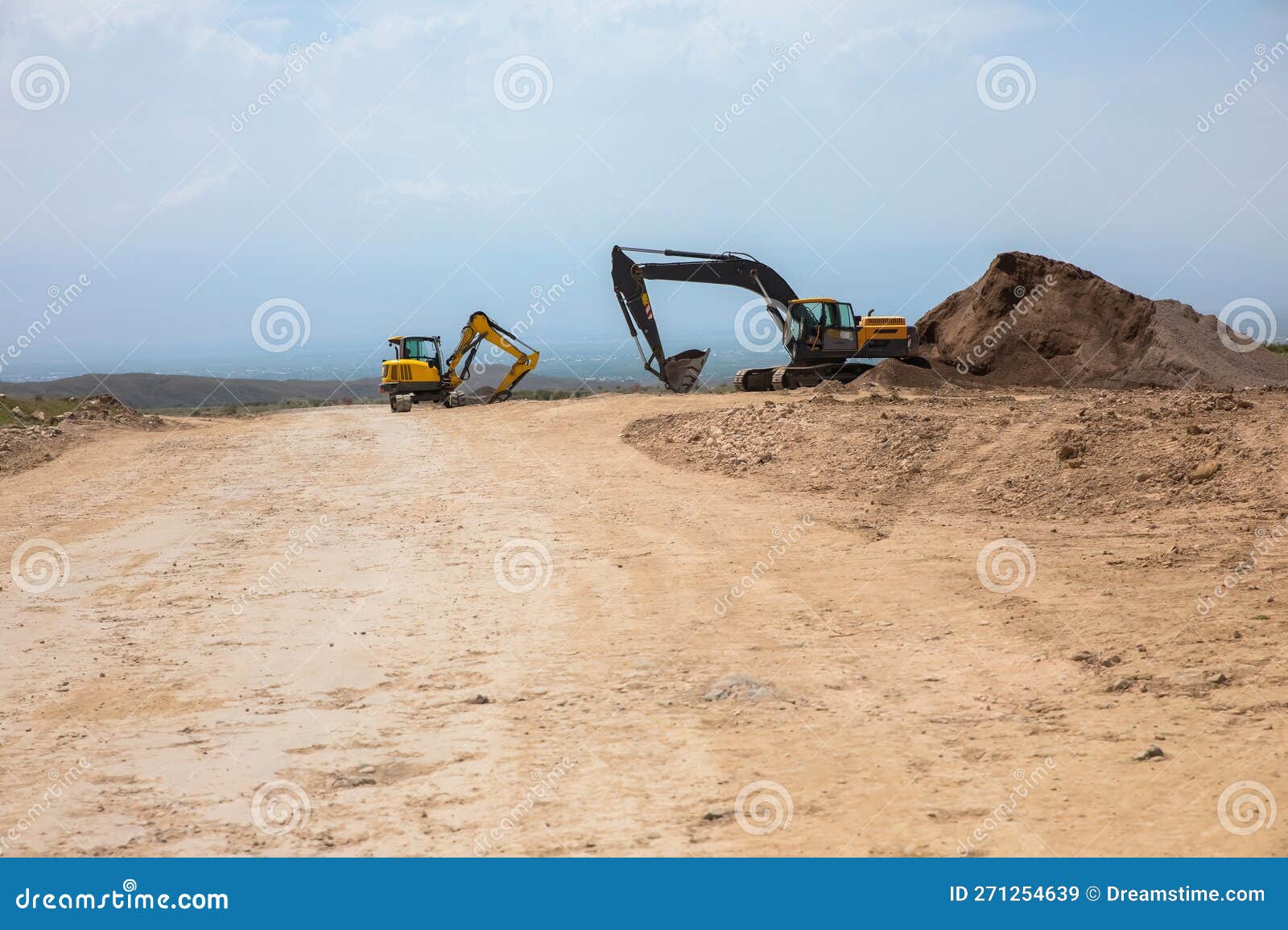 Tracked Excavator Working At A Construction Site During Laying Or ...