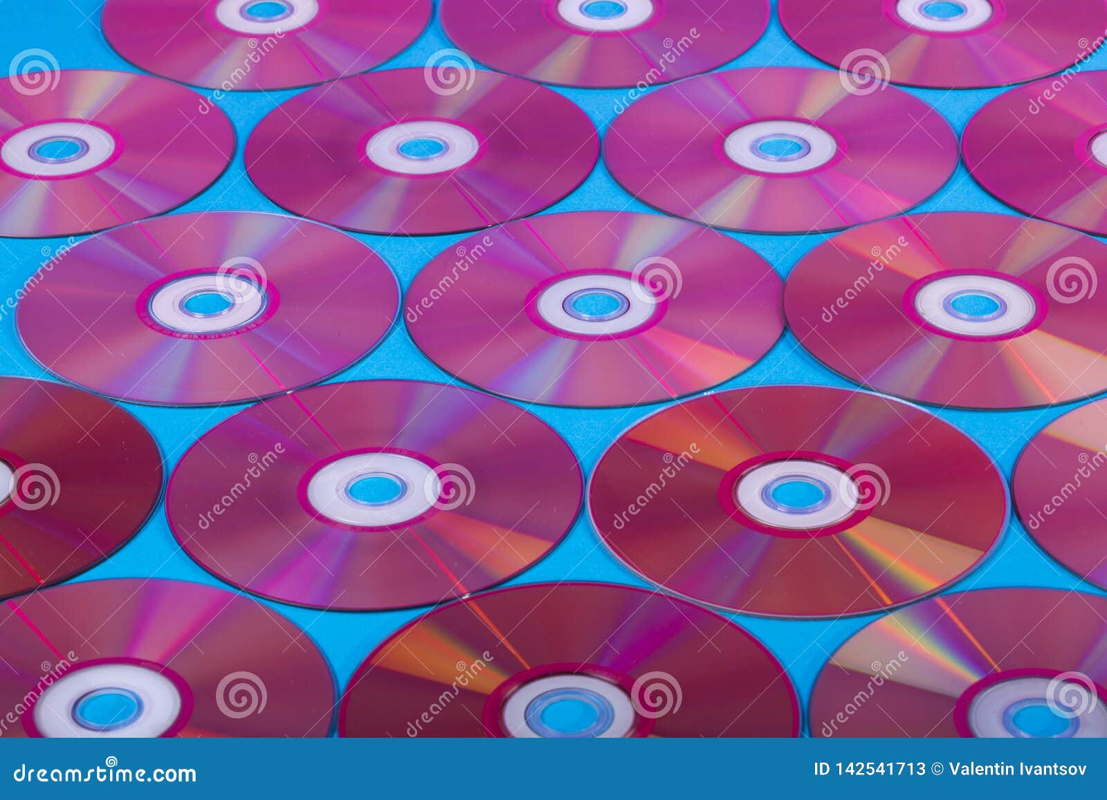 Laser Compact Discs on a Blue Background with Color Reflection Stock ...
