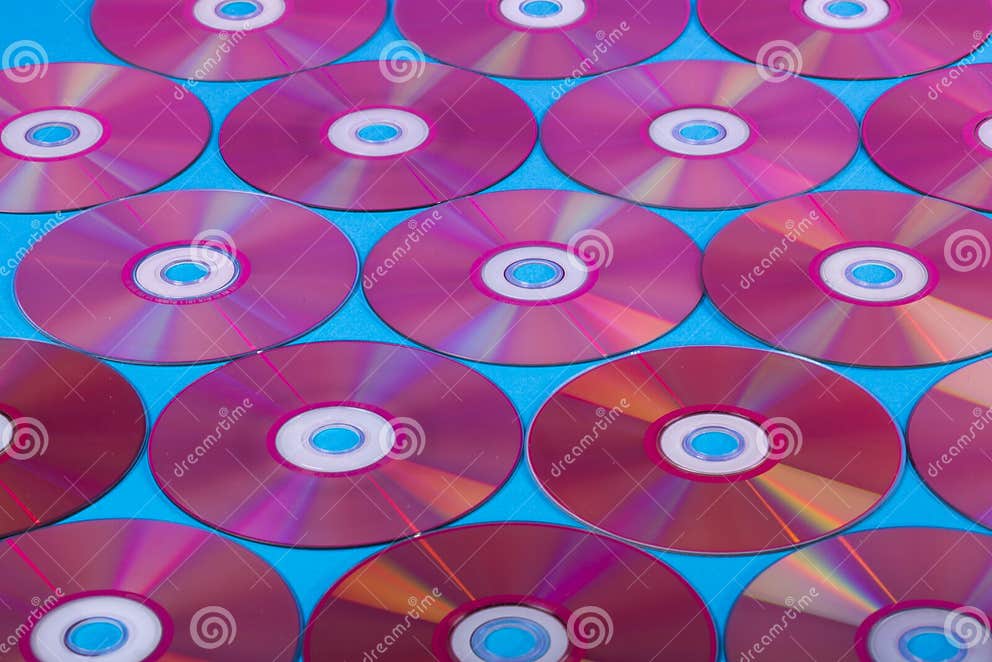 Laser Compact Discs on a Blue Background with Color Reflection Stock ...