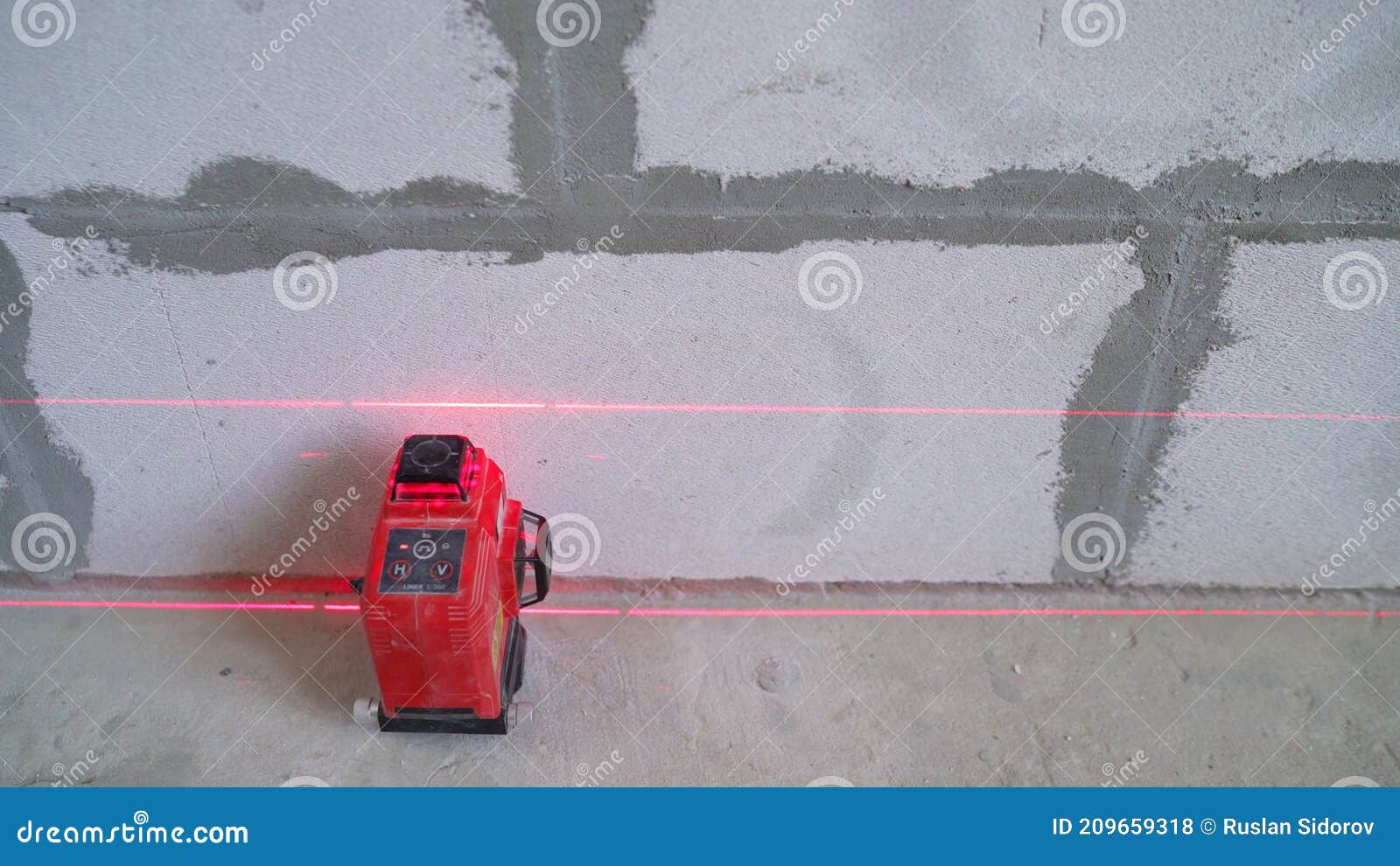 A Builder Makes Arrangements with a Laser Level at a Construction Site ...