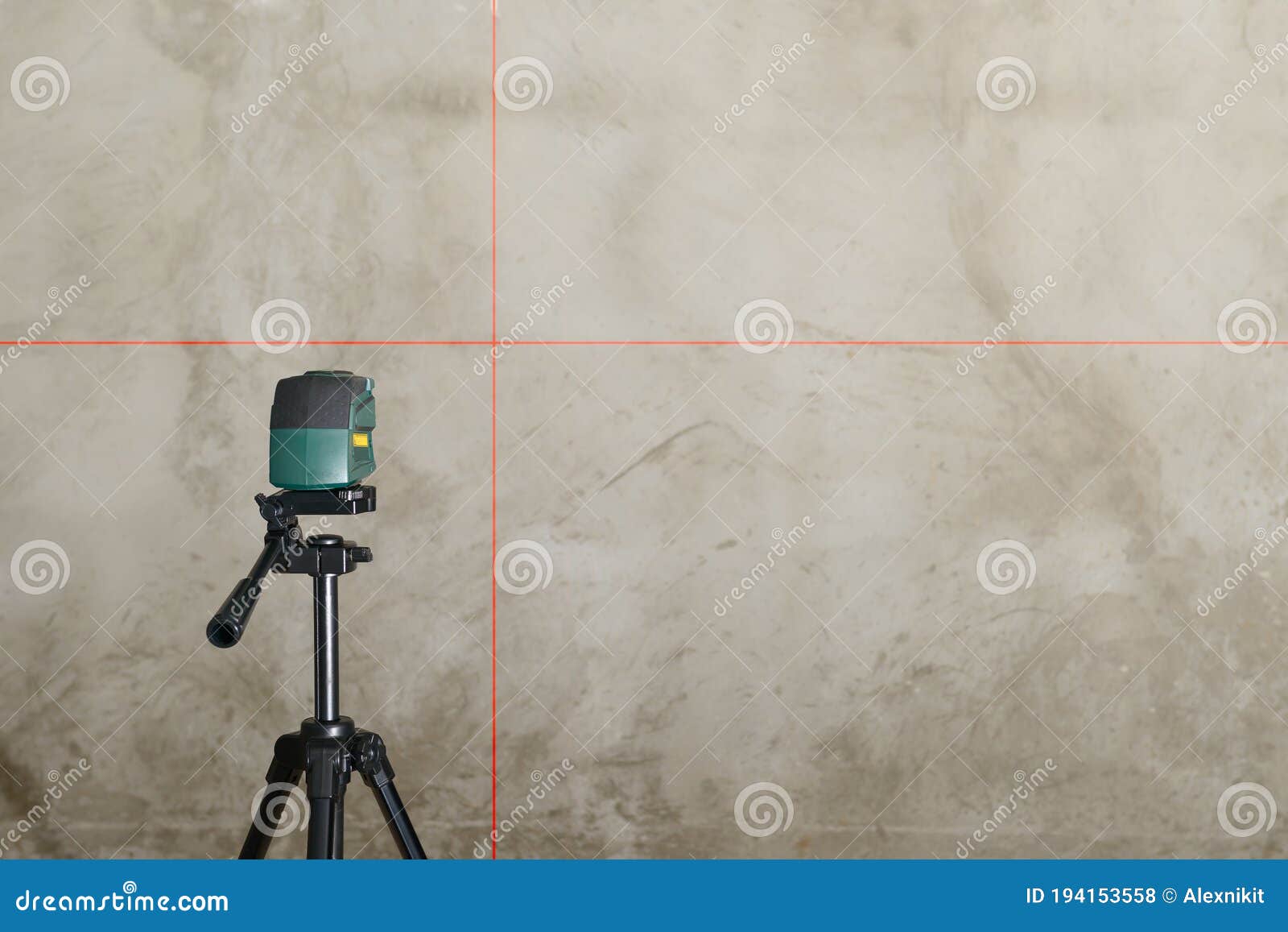 The Laser Level Stands on a Tripod and Projects Its Beams Onto a Wall ...