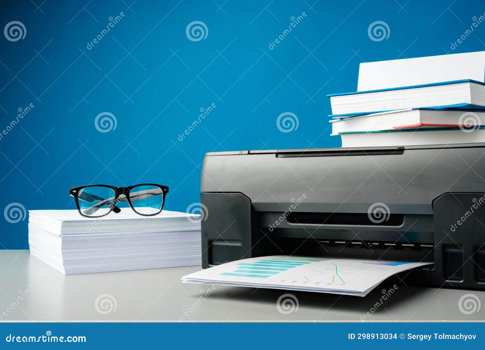 Laser Printer on Desk Against Blue Background. Stock Photo - Image of ...
