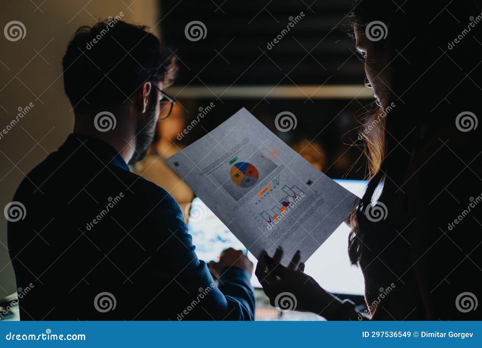 Diverse Business Team Collaborating Late at Night, Analyzing Reports ...