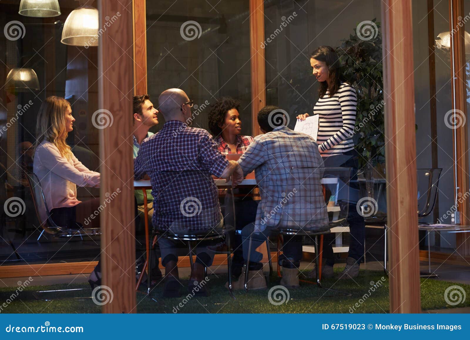 Late Night Meeting Around Table in Design Office Stock Image - Image of ...