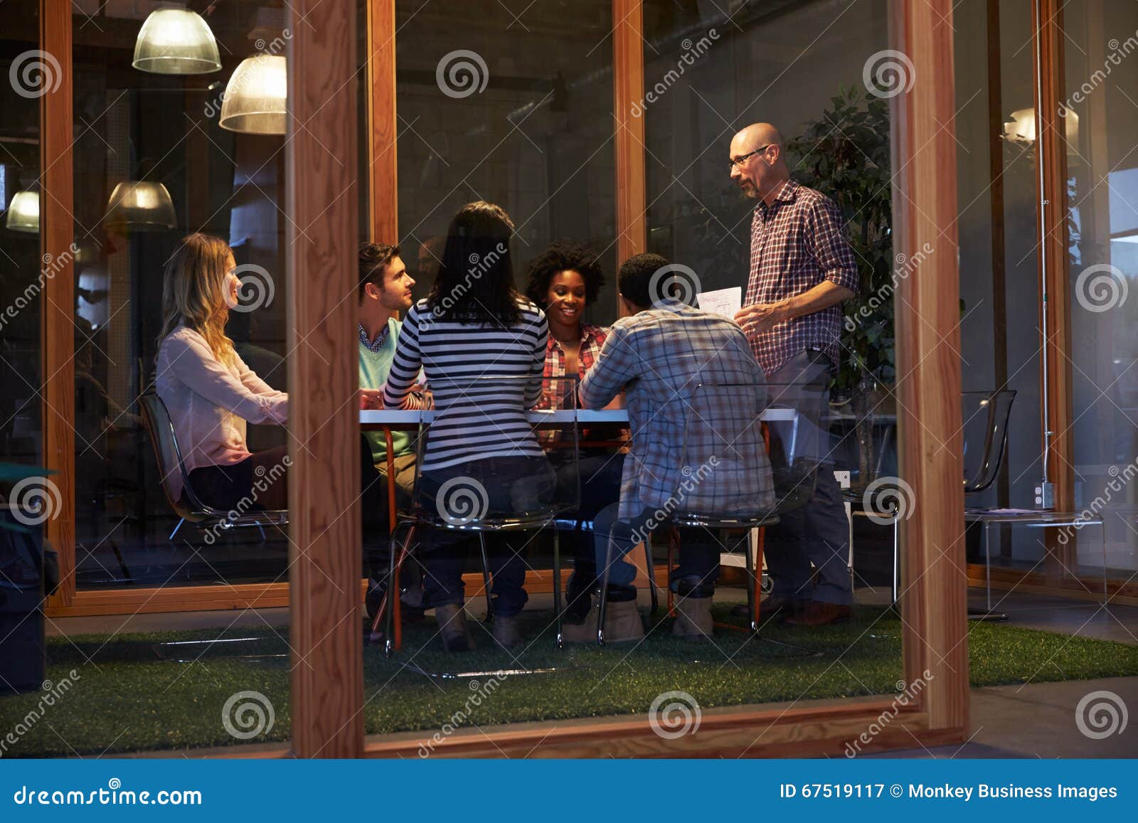 Late Night Meeting Around Table in Design Office Stock Image - Image of ...