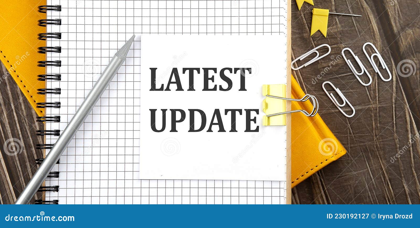 LATEST UPDATE Text on a Sticker on the Notebook, Wooden Background ...