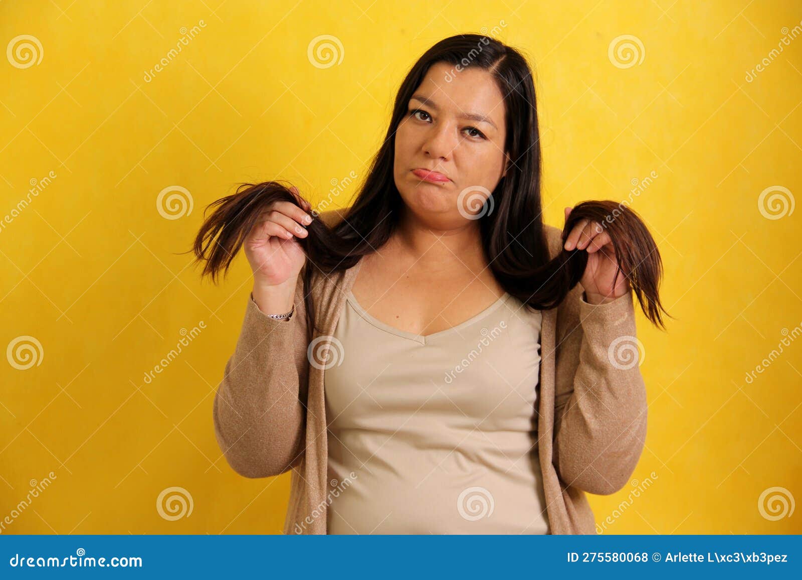Latin Adult Woman With Very Long Straight Hair Suffers And Is Sad Because Her Hair Is A Mess And