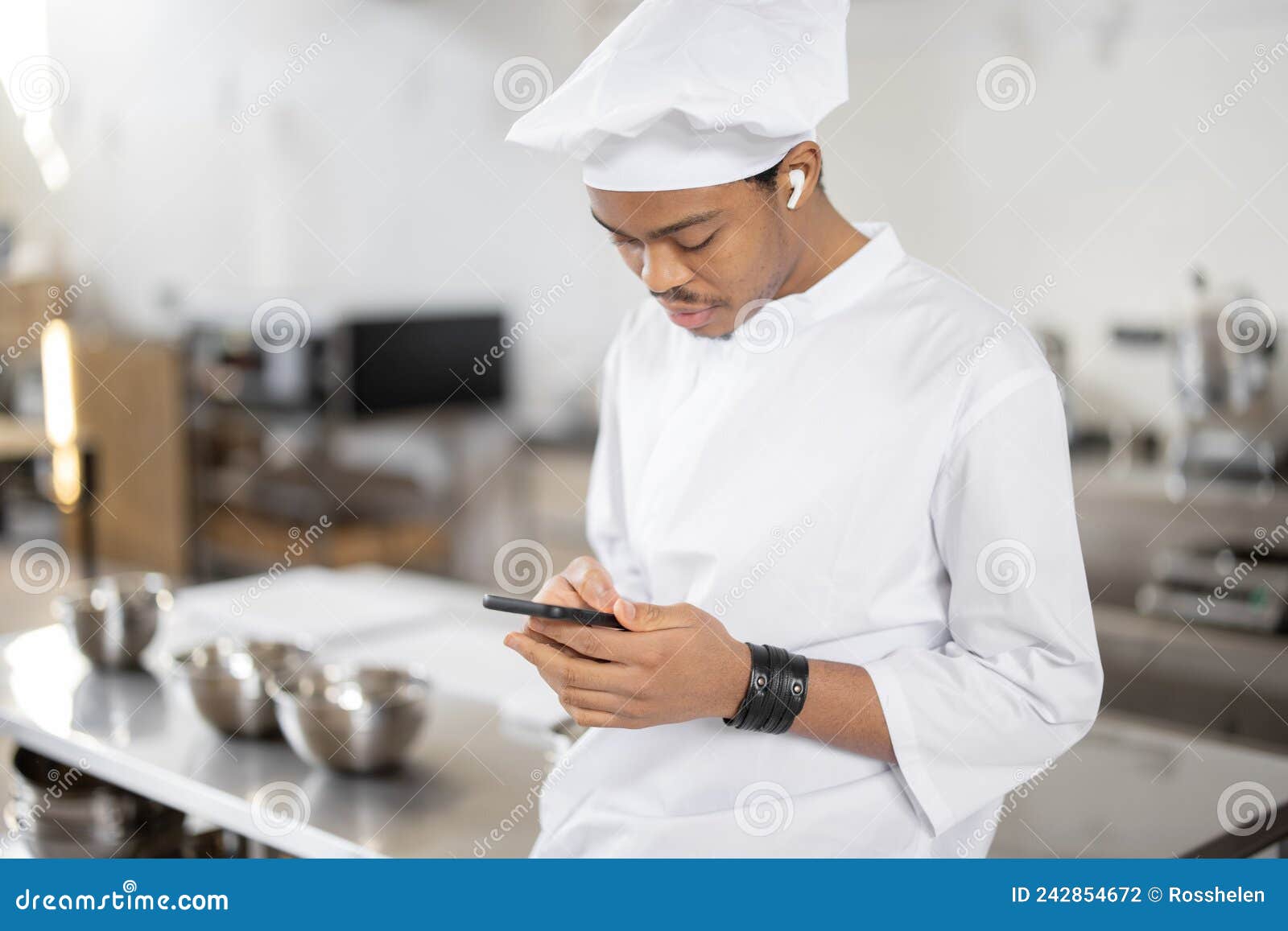 Latin Chef with Phone in Professional Restaurant Kitchen Stock Photo ...