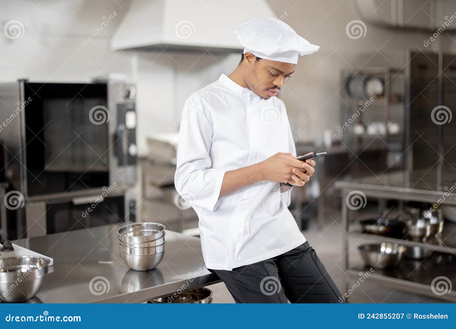 Latin Chef with Phone in Professional Restaurant Kitchen Stock Image ...