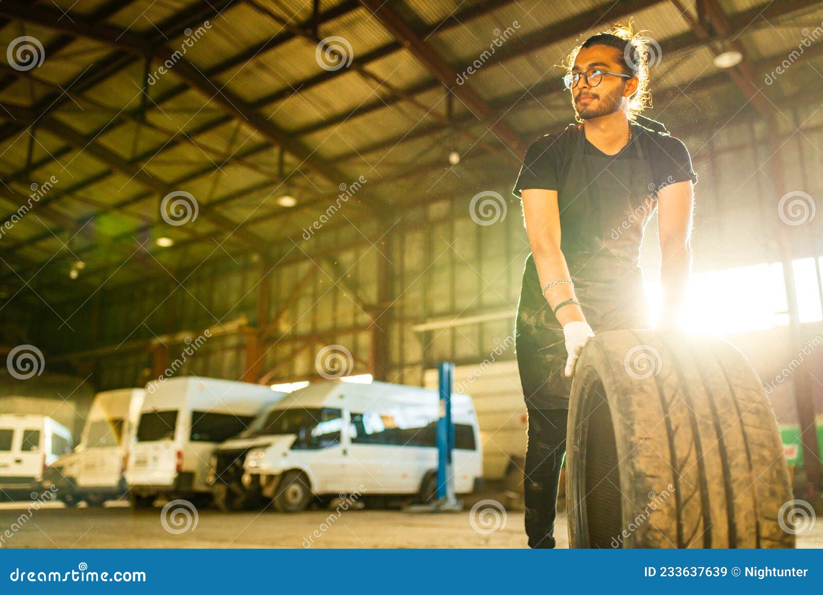 Latin Hispanic Auto Mechanic in Uniform is Examining a Car while ...